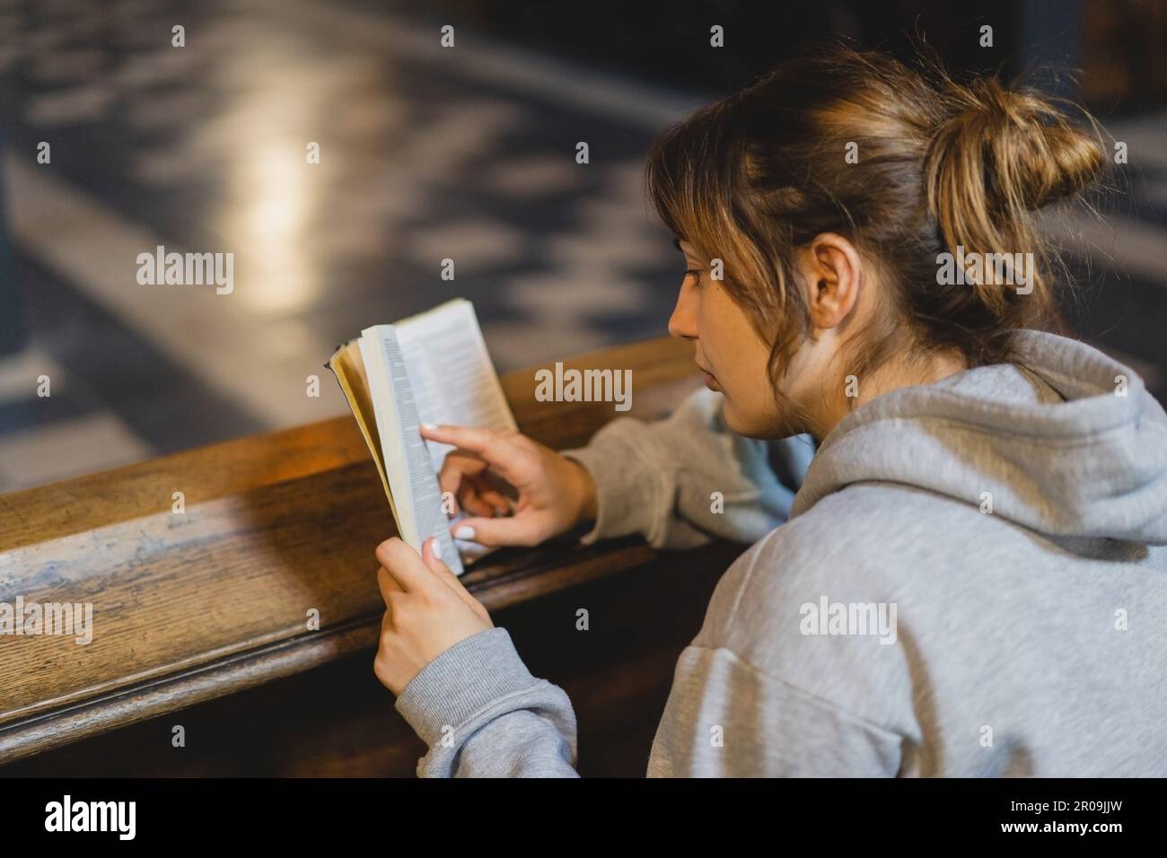 Christian woman reading bible in an ancient Catholic temple. Reading ...