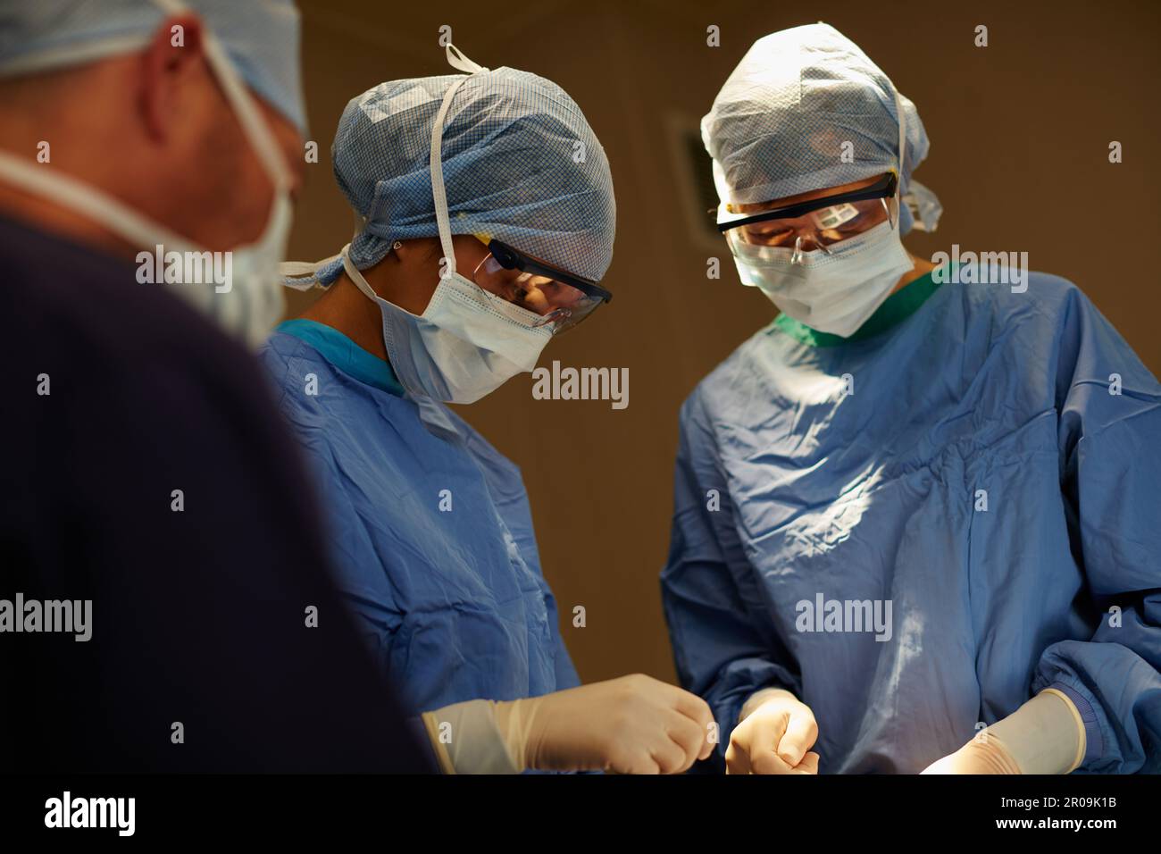 Skilled in saving lives. a team of surgeons performing a surgical ...