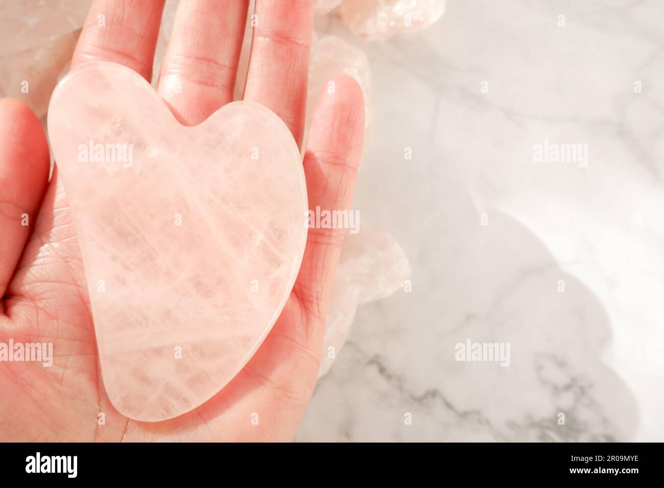 gua sha.Rose quartz massage scraper in the shape of a heart from ...