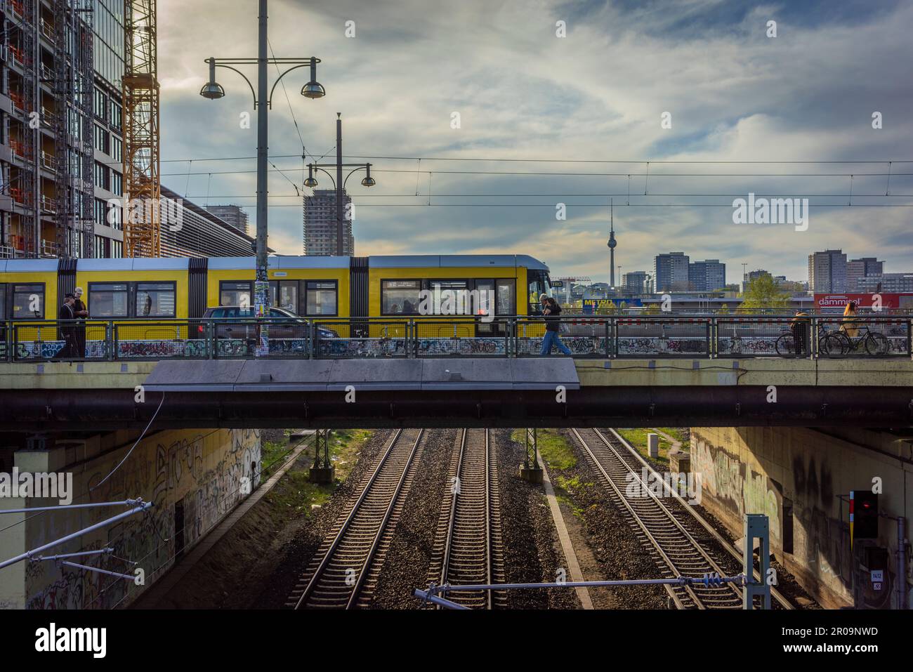 A yellow tram going over Warschauer Brücke,(Warschauer bridge) at ...