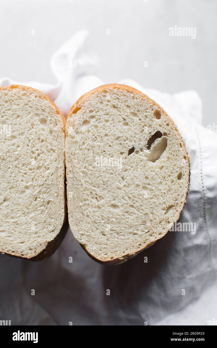 Cross-section of artisan bread cut into half, top view of sesame coated ...