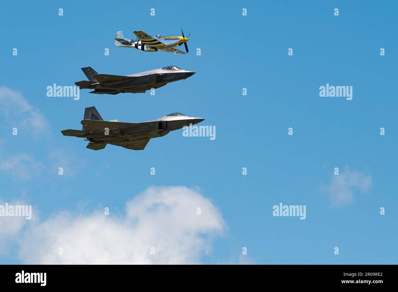 A U.S. Air Force F-22 Raptor, F-35A and P-51 Mustang fly stacked during ...