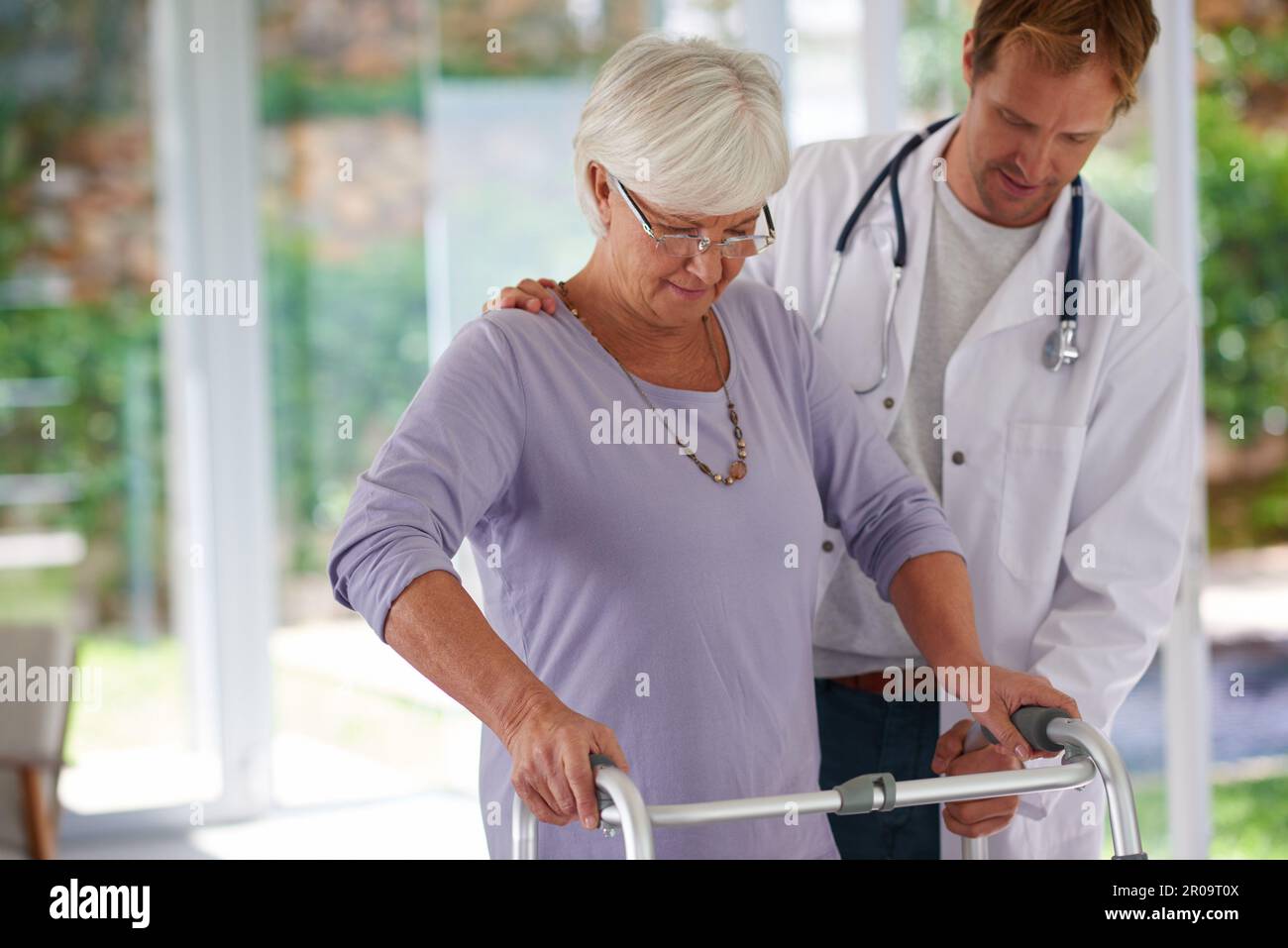 All the support she needs. a senior woman being helped by her doctor to ...