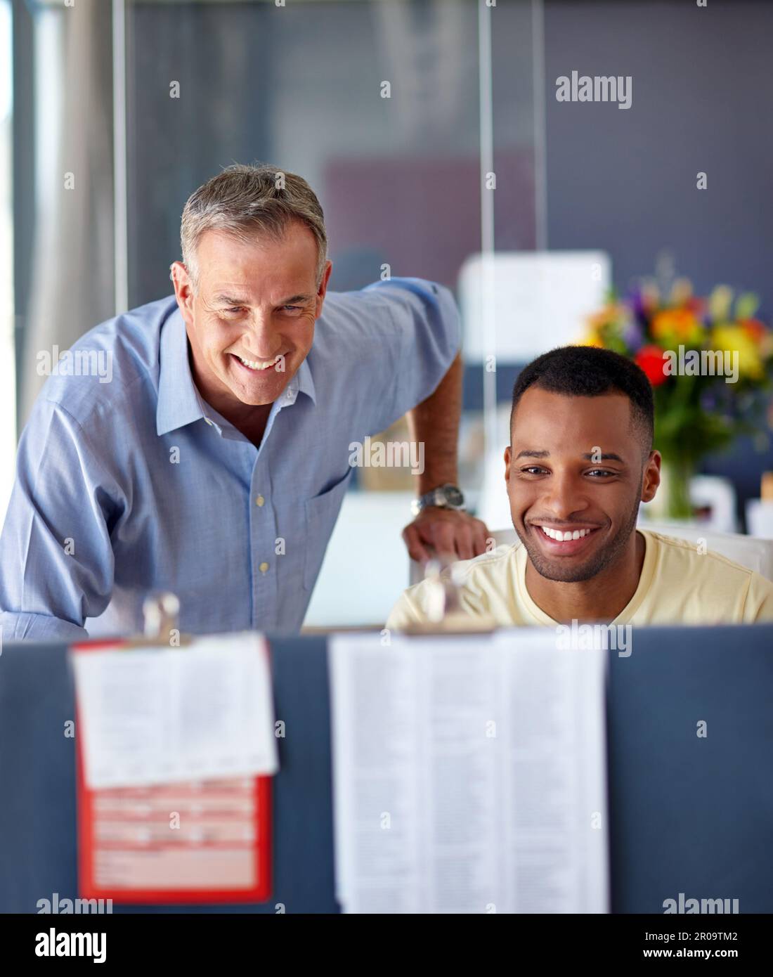 Its a job well done. two professionals working together in an office ...