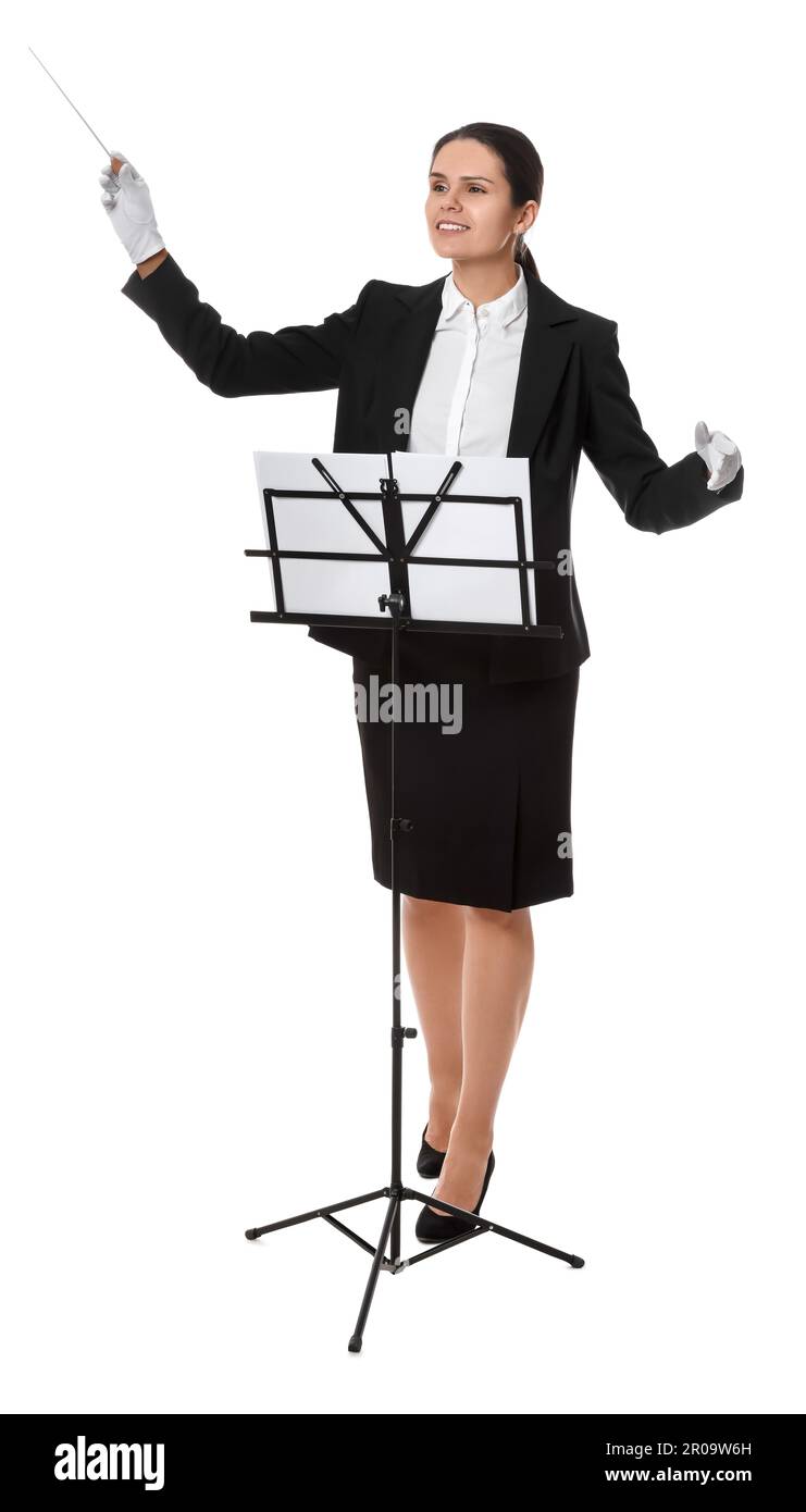 Happy young conductor with baton and note stand on white background ...
