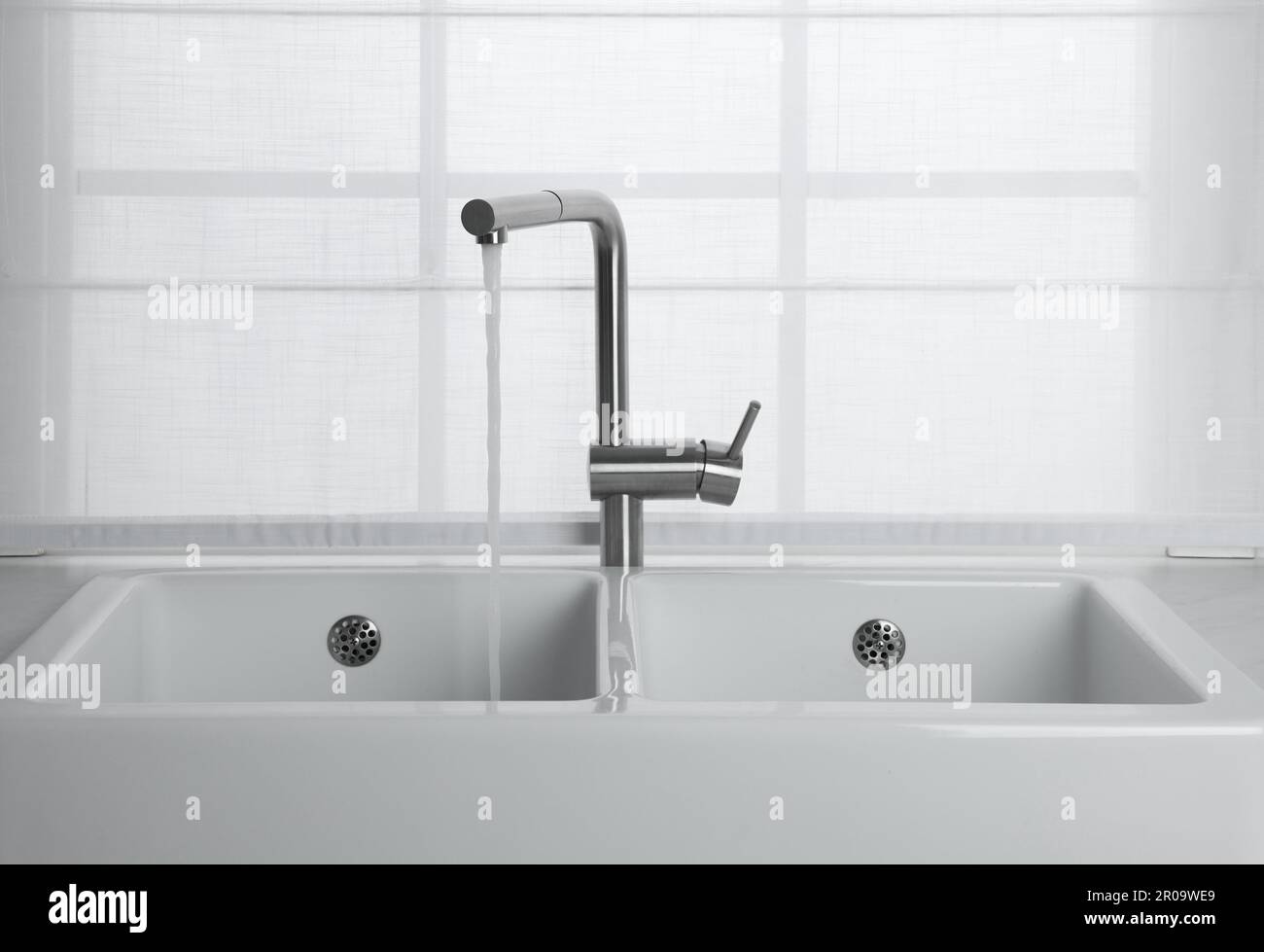 Stream of water flowing from tap in kitchen Stock Photo - Alamy