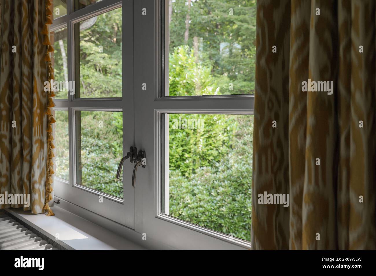 Old fashioned window with beautiful curtains in room. Interior design ...