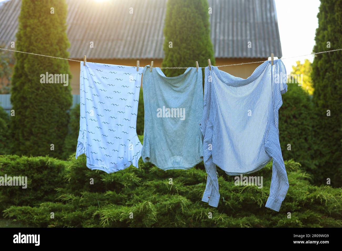 Shirts drying on washing line at backyard of house Stock Photo - Alamy
