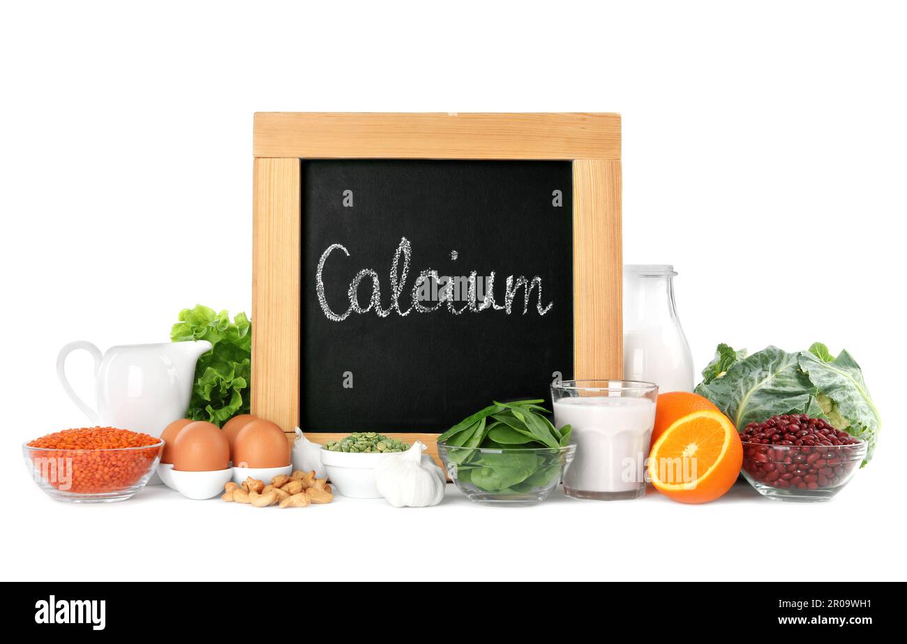 Set of natural food and chalkboard with written word Calcium on white ...