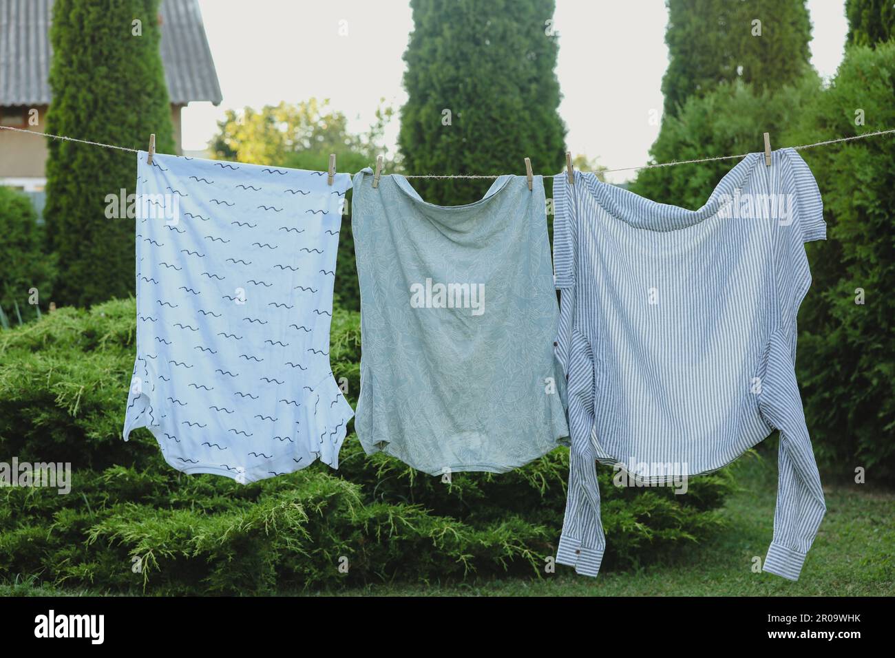 Shirts drying on washing line at backyard of house Stock Photo - Alamy