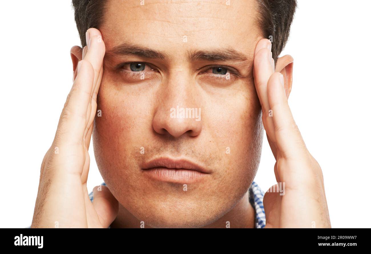 Ive got a severe headache. Portrait of a young man holding his head as a result of a splitting ...