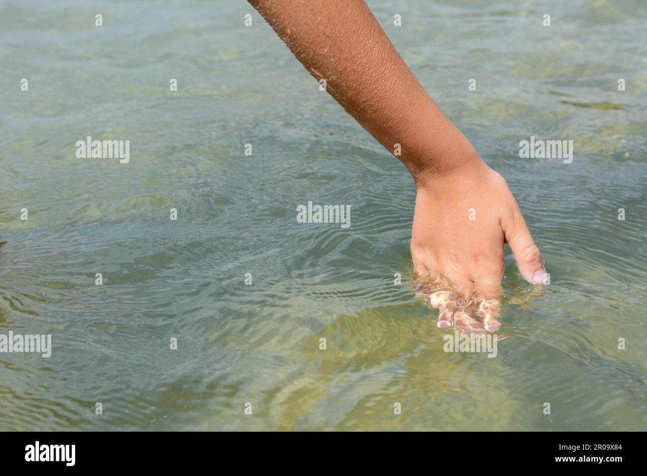 Child touching water hi-res stock photography and images - Alamy