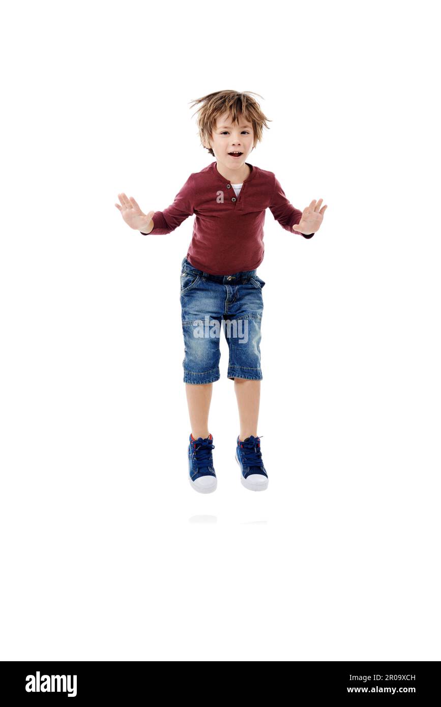 Take a leap if you love life. Studio shot of a cute little boy jumping ...