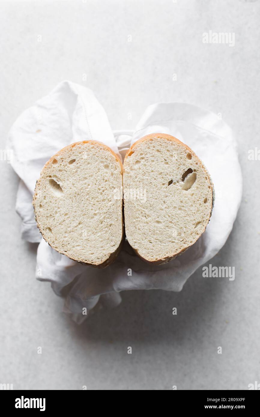 Cross-section of artisan bread cut into half, top view of sesame coated ...