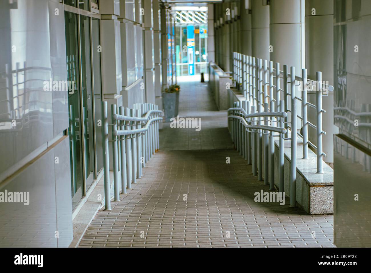 Brick ramp with shiny metal railings inside Stock Photo - Alamy