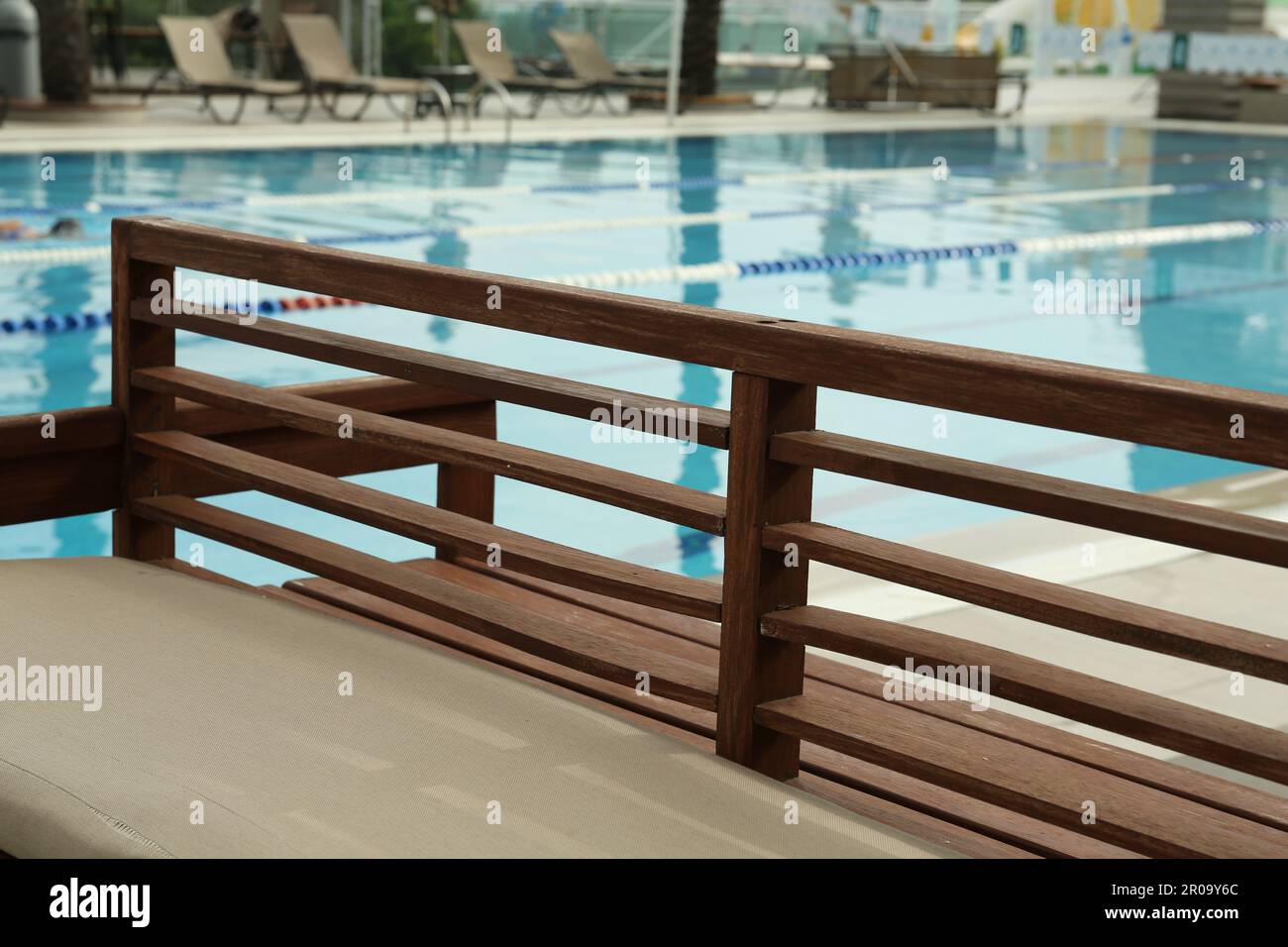Wooden bench near swimming pool at luxury resort Stock Photo - Alamy