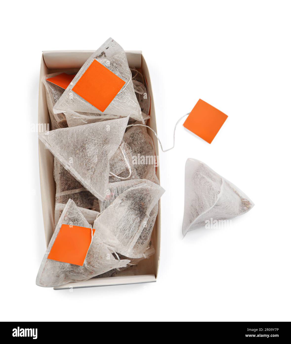 Paper tea bags with tags and box on white background, top view Stock ...