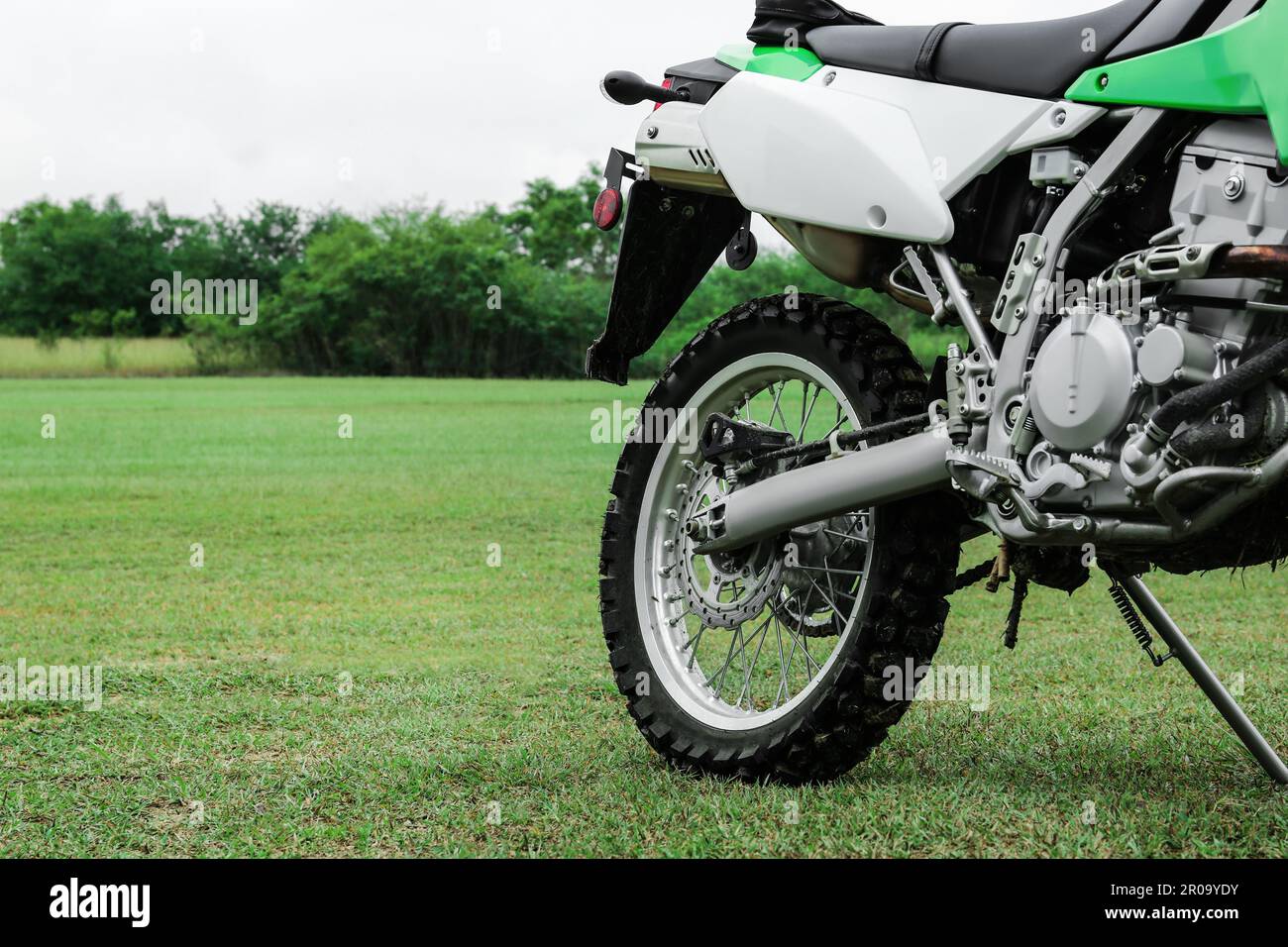Cross motorcycle on green grass outdoors, closeup. Space for text Stock ...