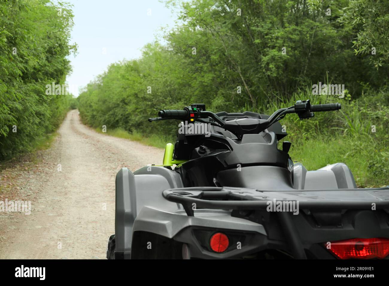Beautiful quad bike on pathway near trees outdoors Stock Photo - Alamy