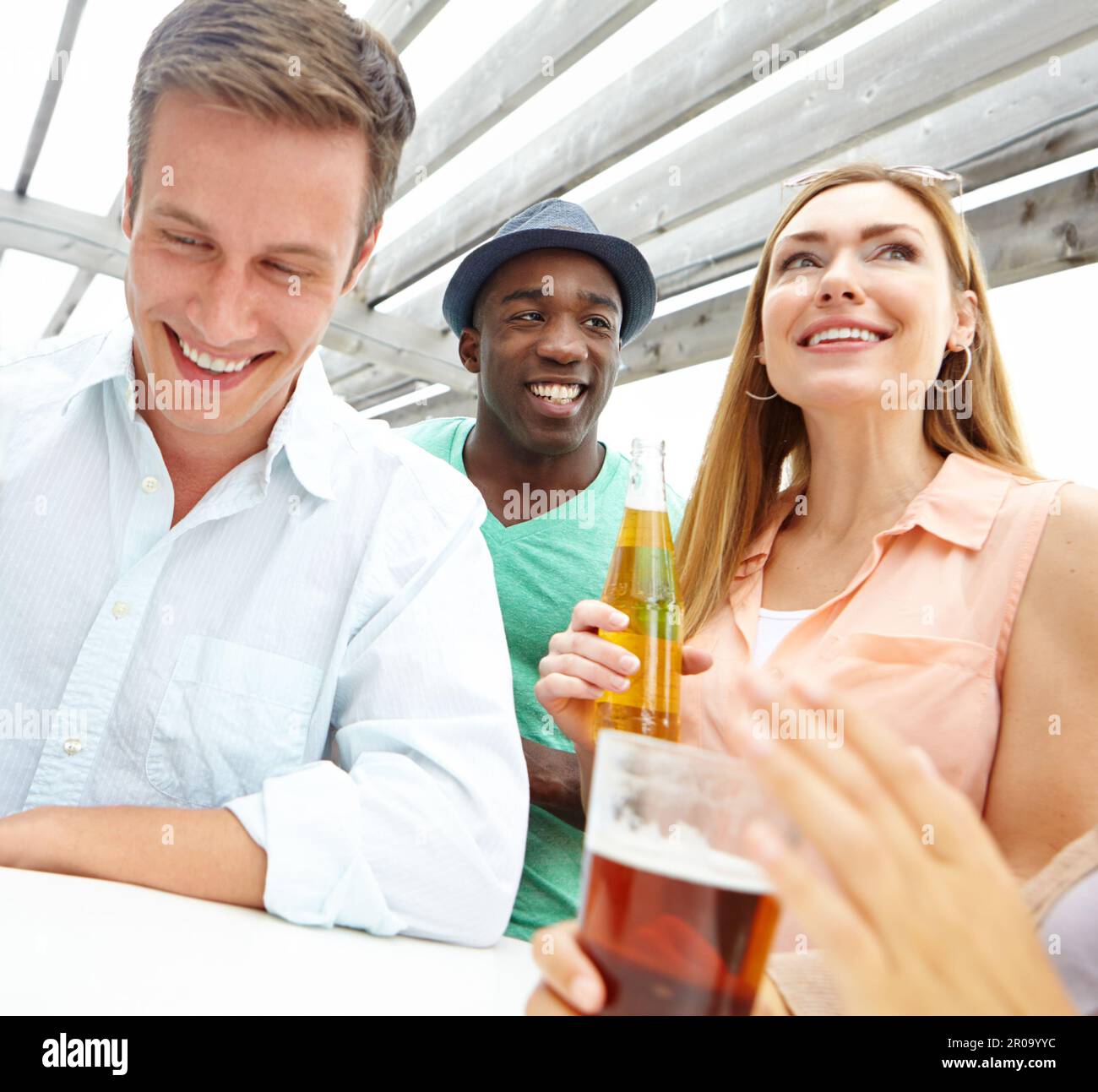 She loves to party. A pretty woman drinking with friends on an outdoor ...