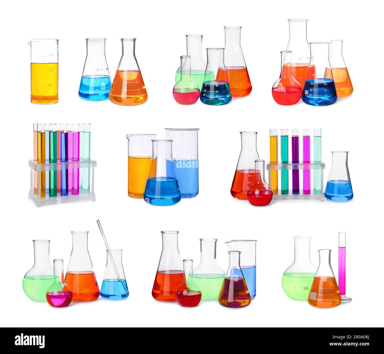 Set of different laboratory glassware with colorful liquids on white ...