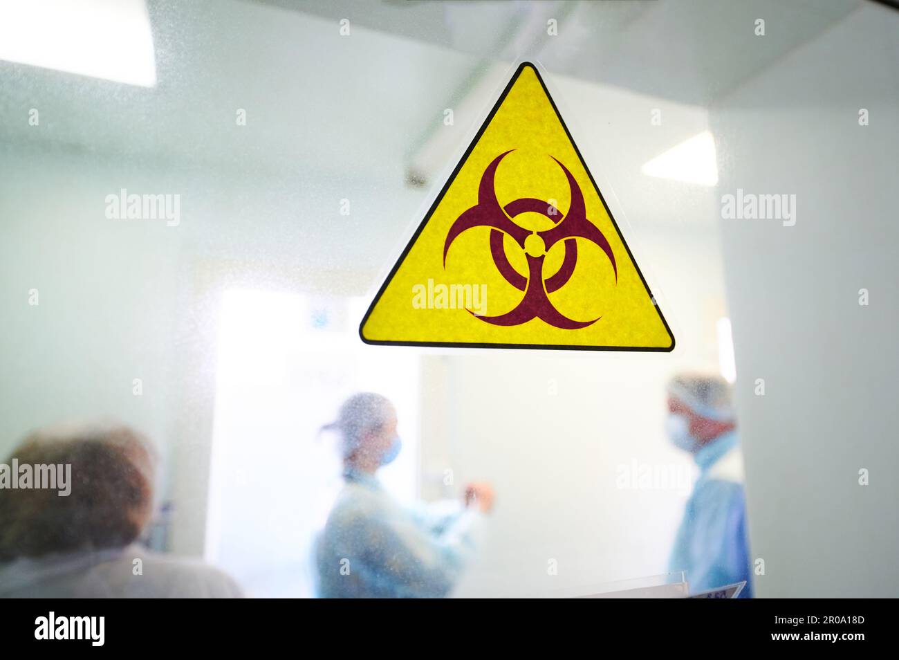 Biohazard warning sign on transparent laboratory door Stock Photo - Alamy