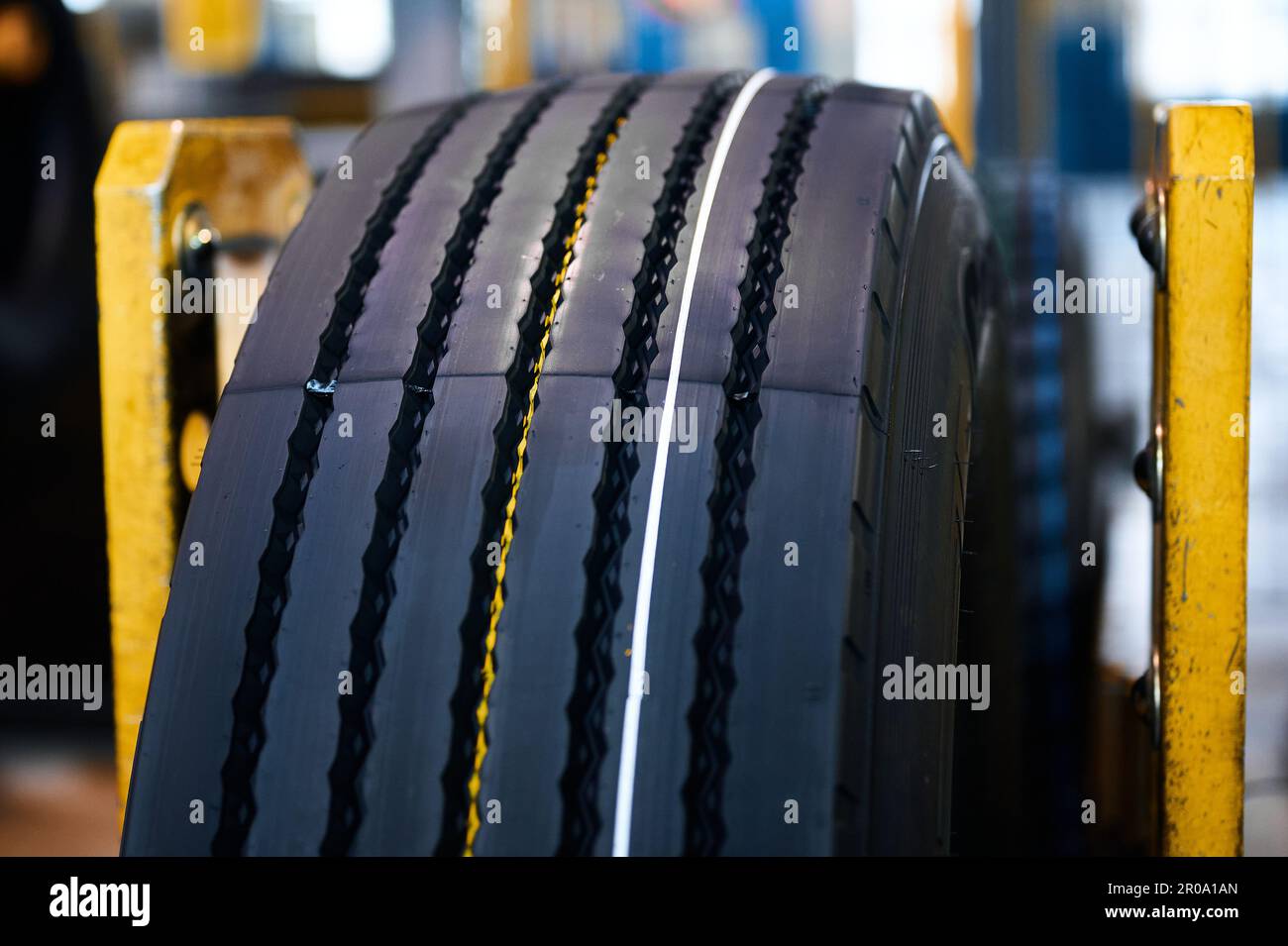 Finished tire with yellow and white color lines on rod at factory Stock ...