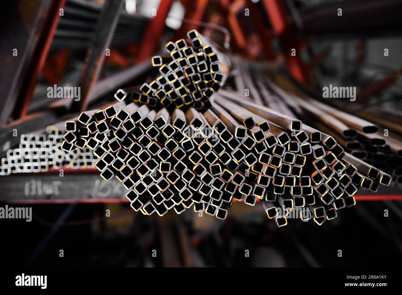 Square tubing pile on rack unit in cold factory warehouse Stock Photo ...