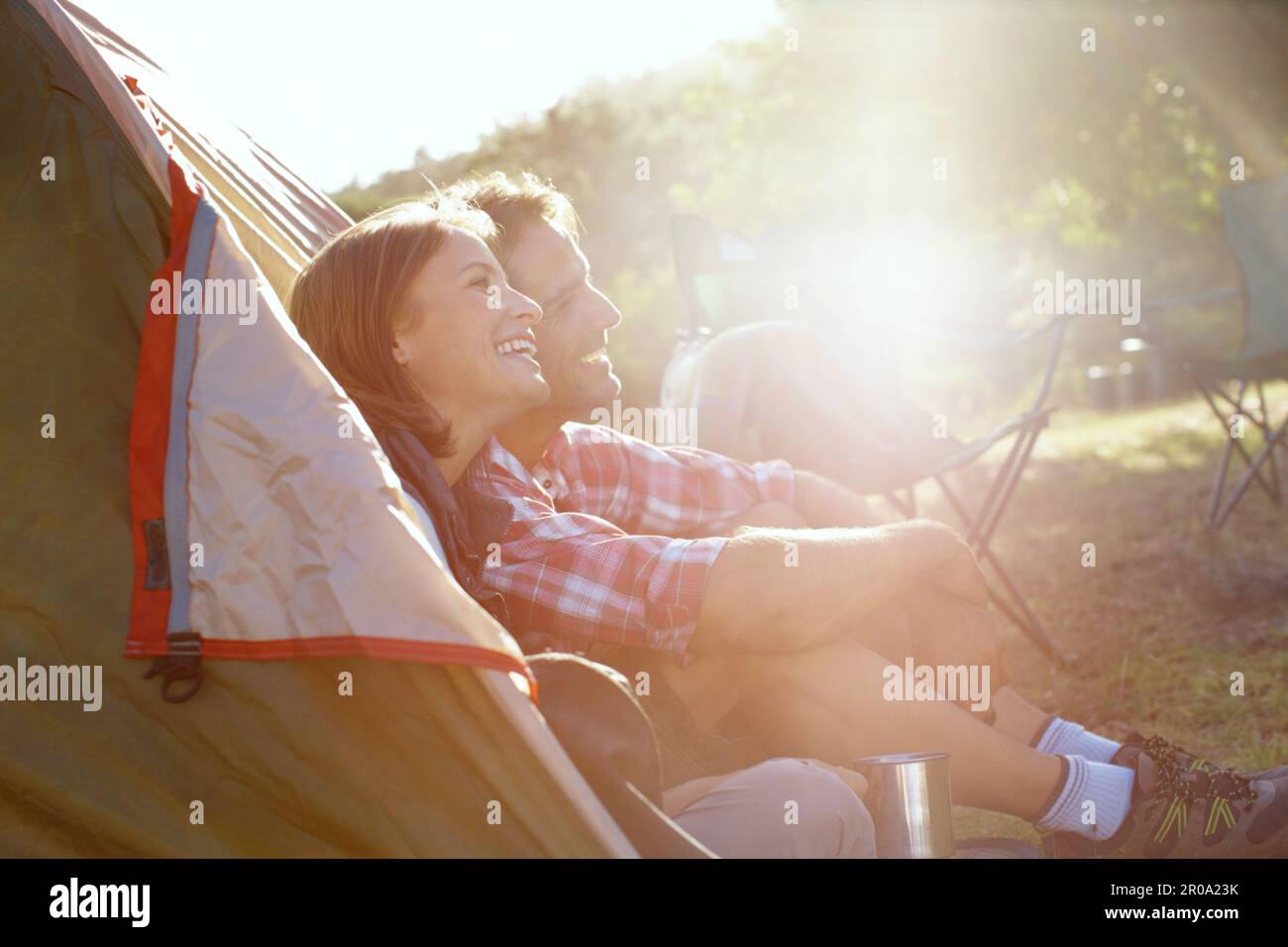 They admire nature. A young couple admiring nature while sitting by ...