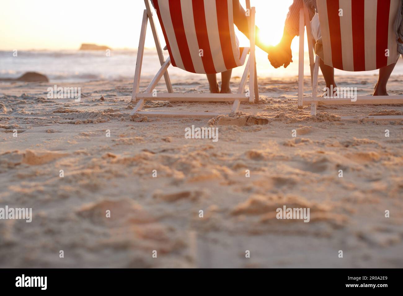 Embracing their love at sunset. An affectionate couple sitting on the ...
