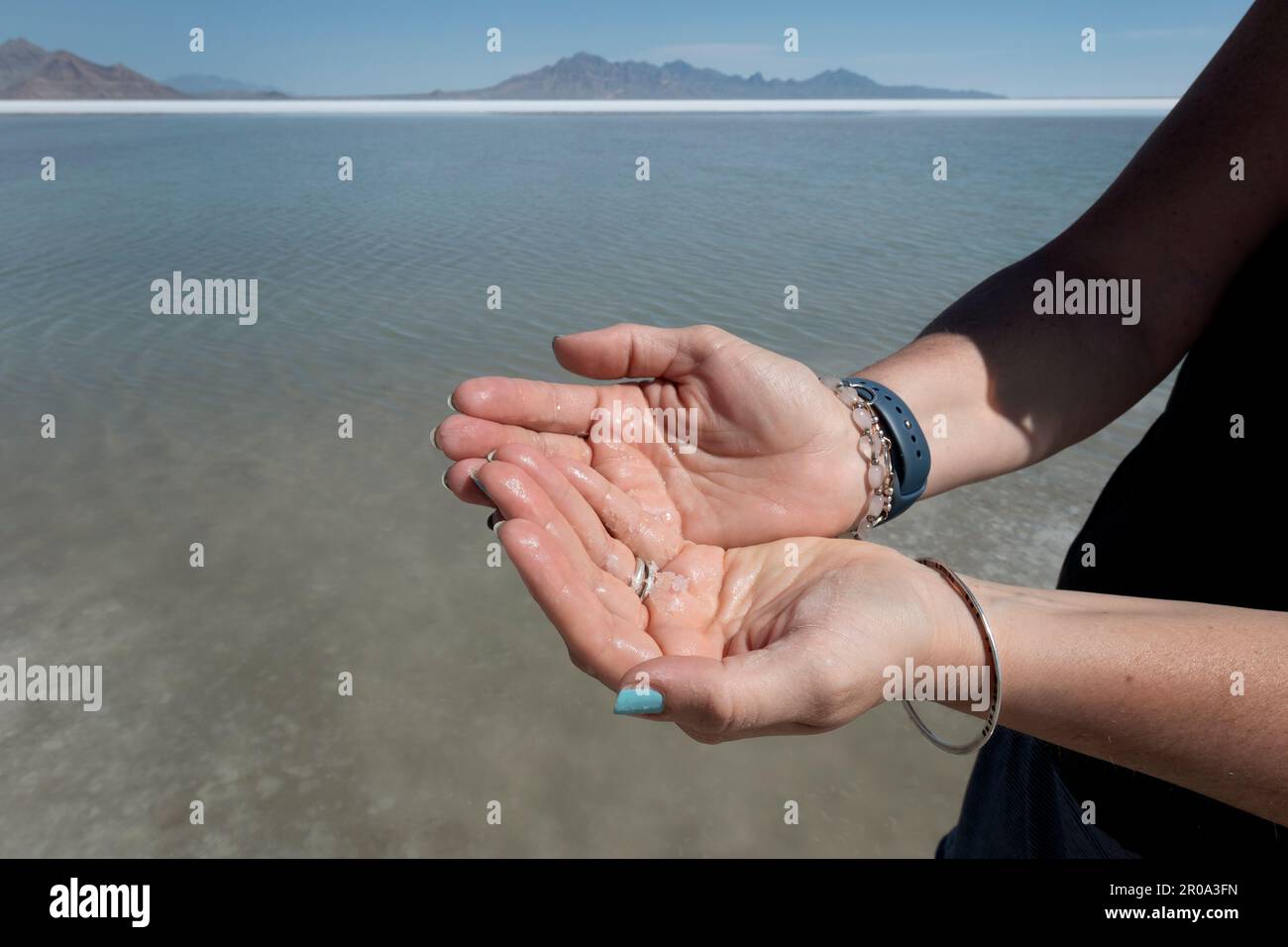 Usa, Utah. Person holding salt crystals from Bonneville Salt Flats ...