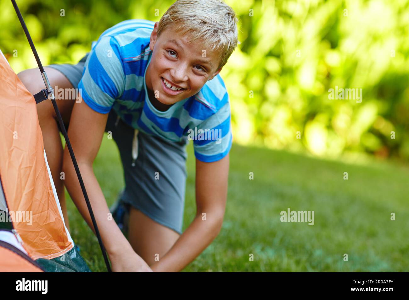 First step setting up camp. Cropped portrait of a young boy putting up ...