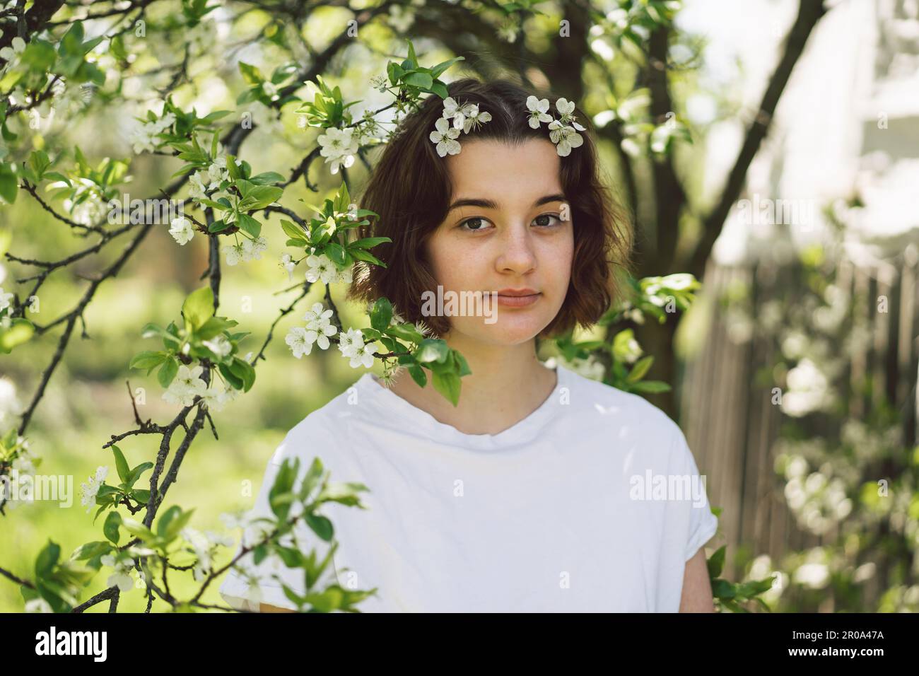 Beautiful teenage girl with spring flowers enjoying nature and laughing ...