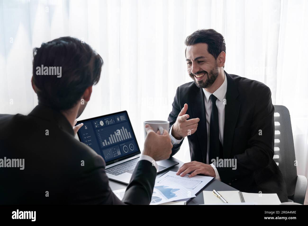 Busy analyst team discussing financial data on digital dashboard ...