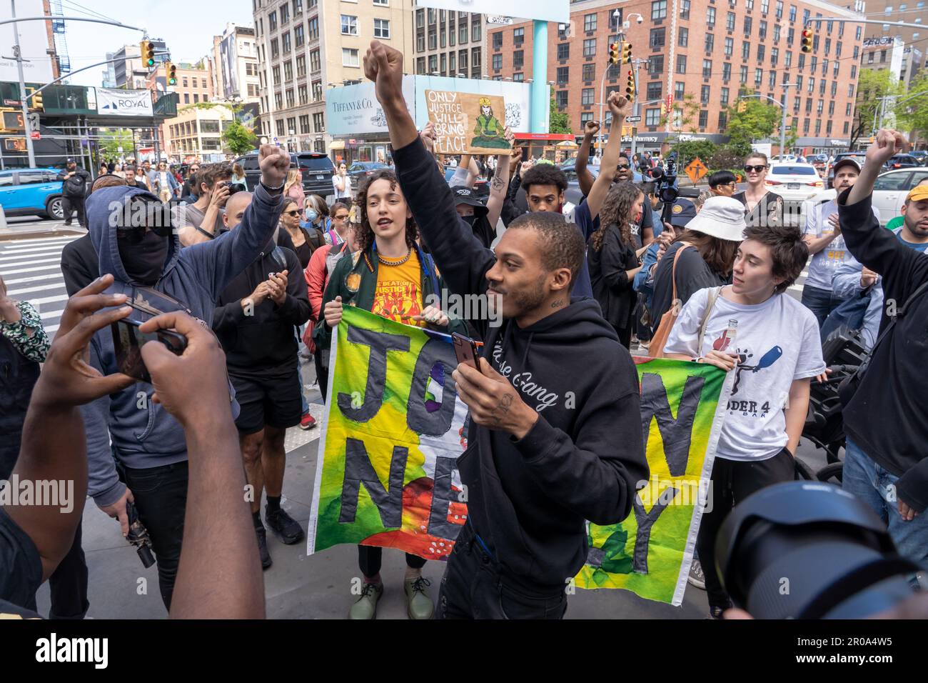 Protesters gesture as they march from the Broadway-Lafayette subway ...