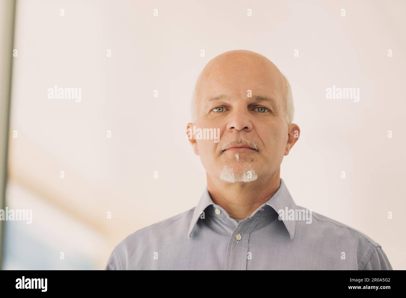 Strong and determined man, now no longer young, stares at you ...