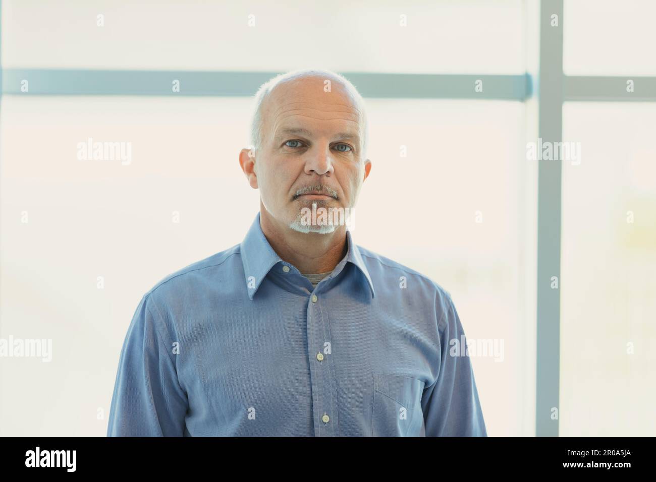 Strong and determined man, now no longer young, stares at you ...