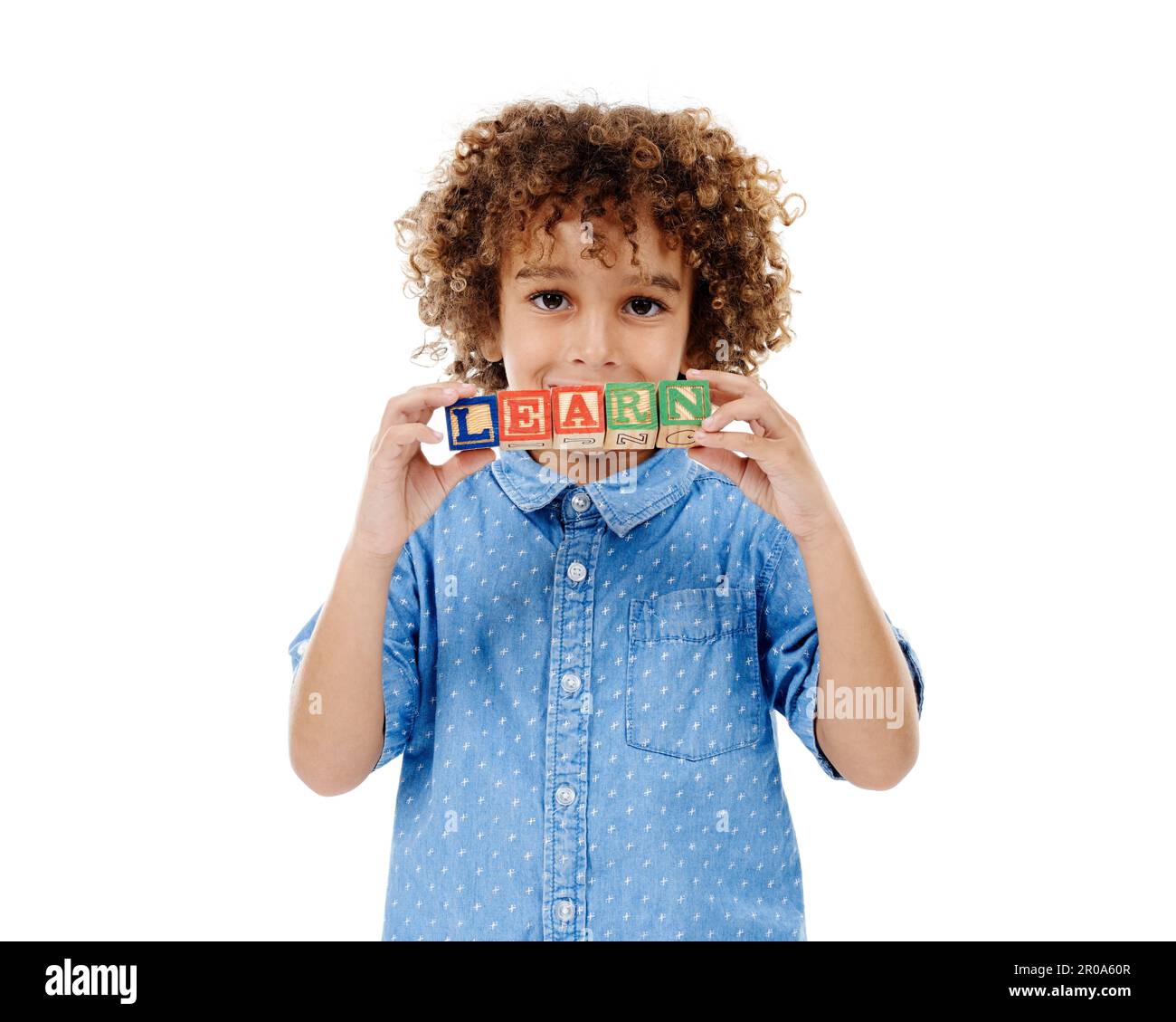 Learning new things every day. Studio shot of a cute little boy holding ...