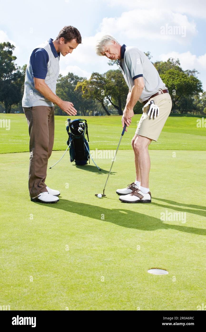 Now, try to keep a straight line...Two men playing a round of golf ...