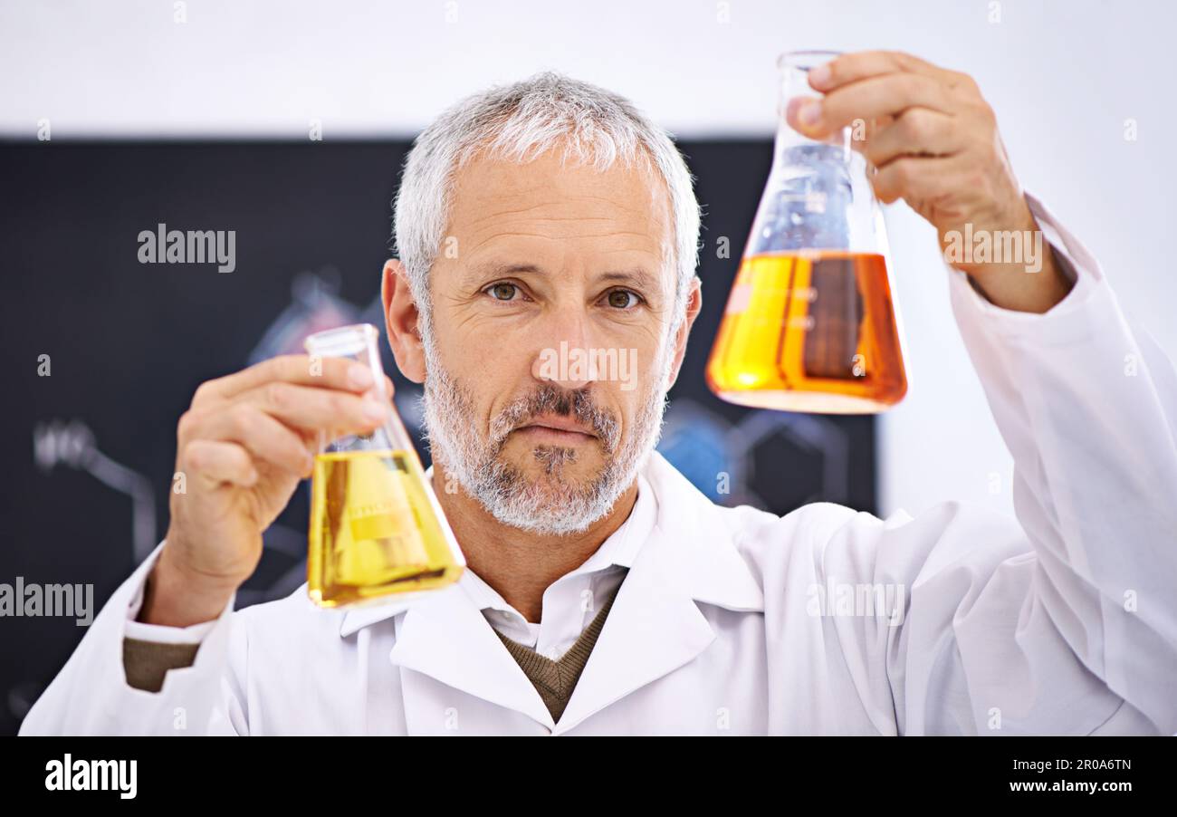 Portrait of a scientist holding liquid in a flask hi-res stock ...