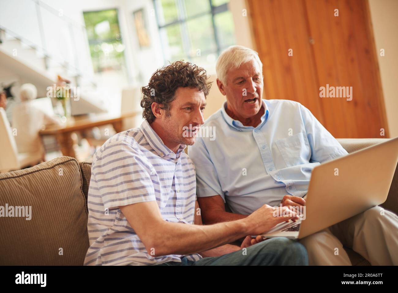 Explaining technology basics to his dad. a man and his father using a ...