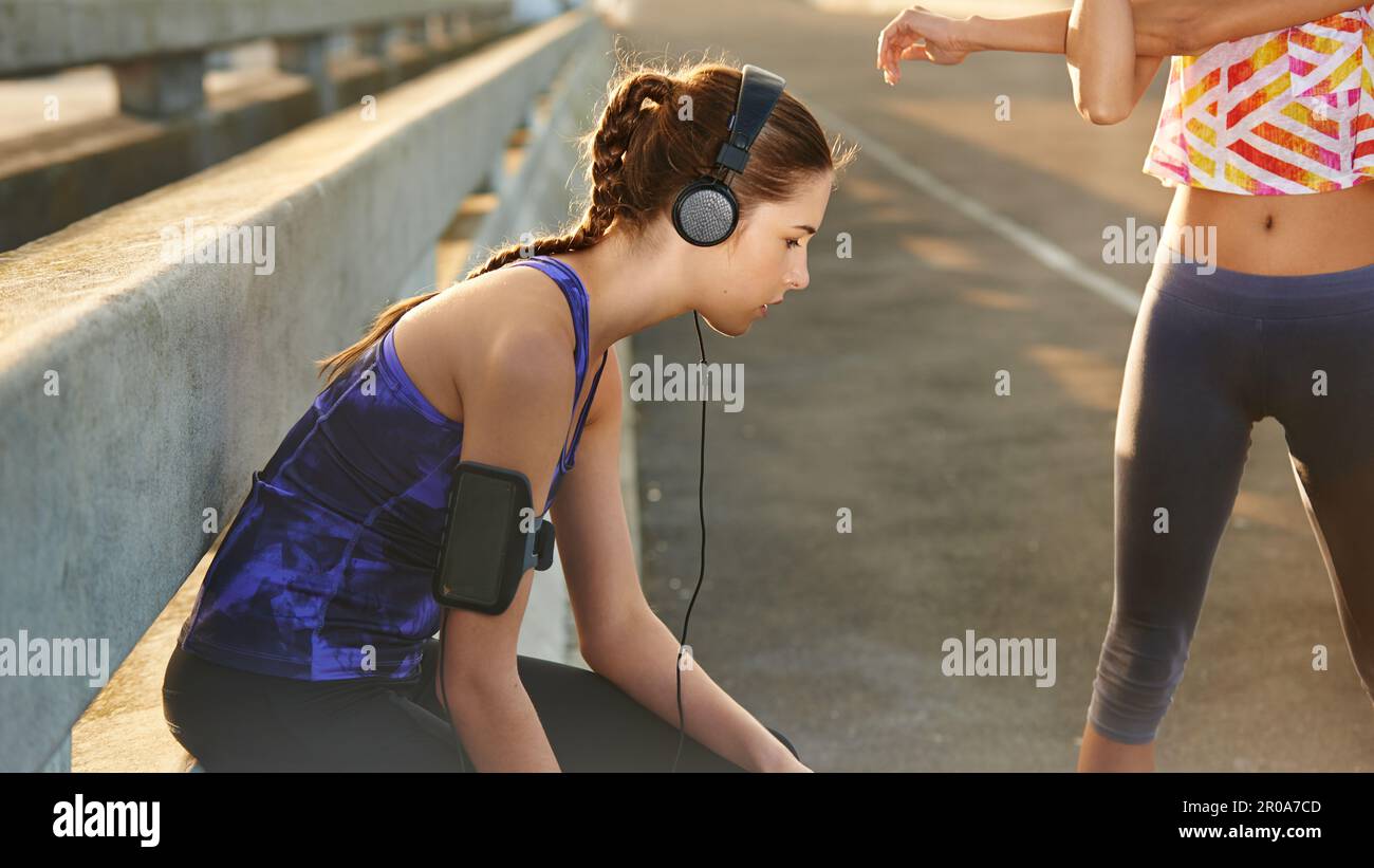 Music gets me psyched to run. a young female jogger listening to music ...