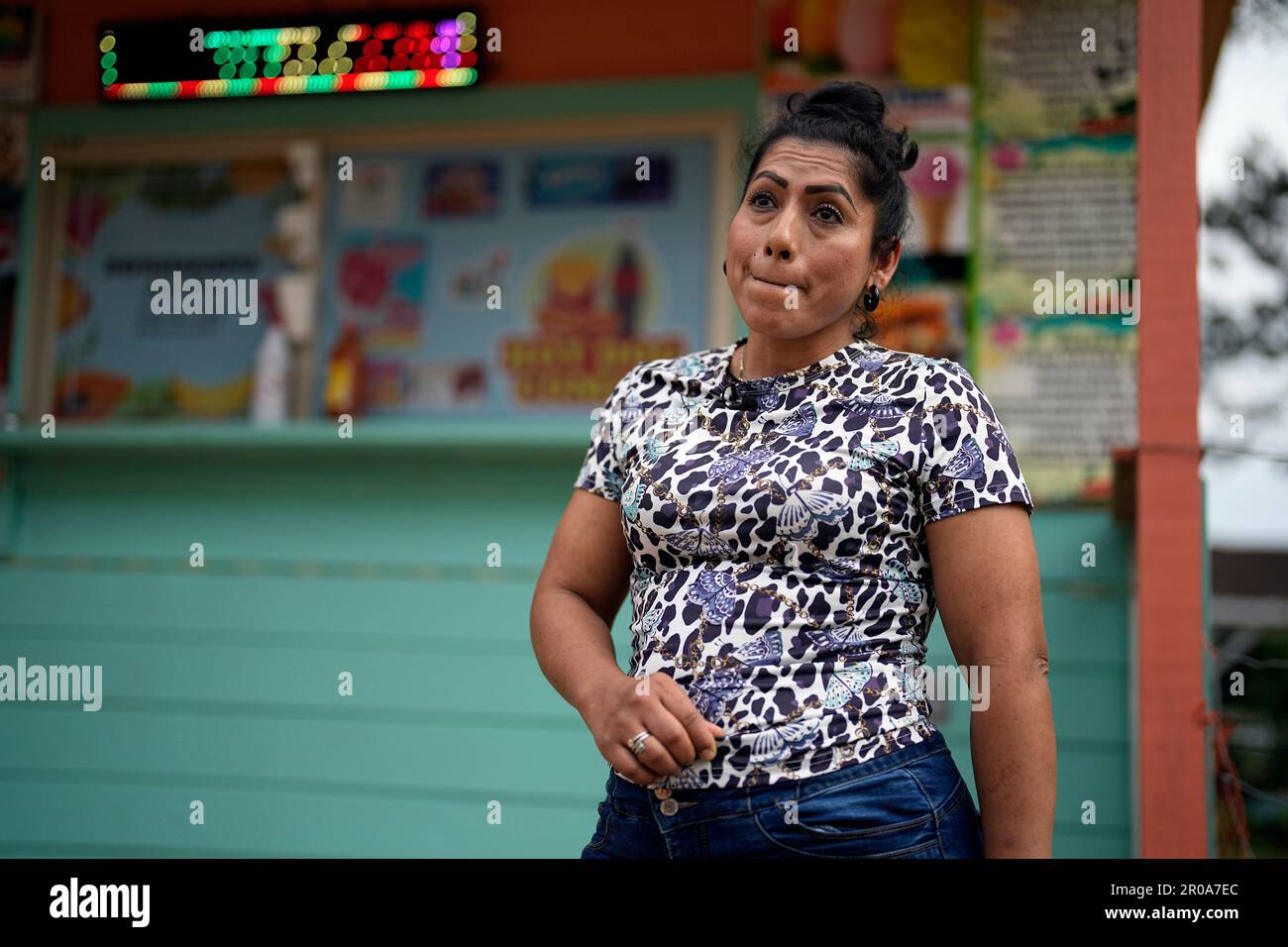 Manuela Lara talks about the neighborhood while standing in front of ...