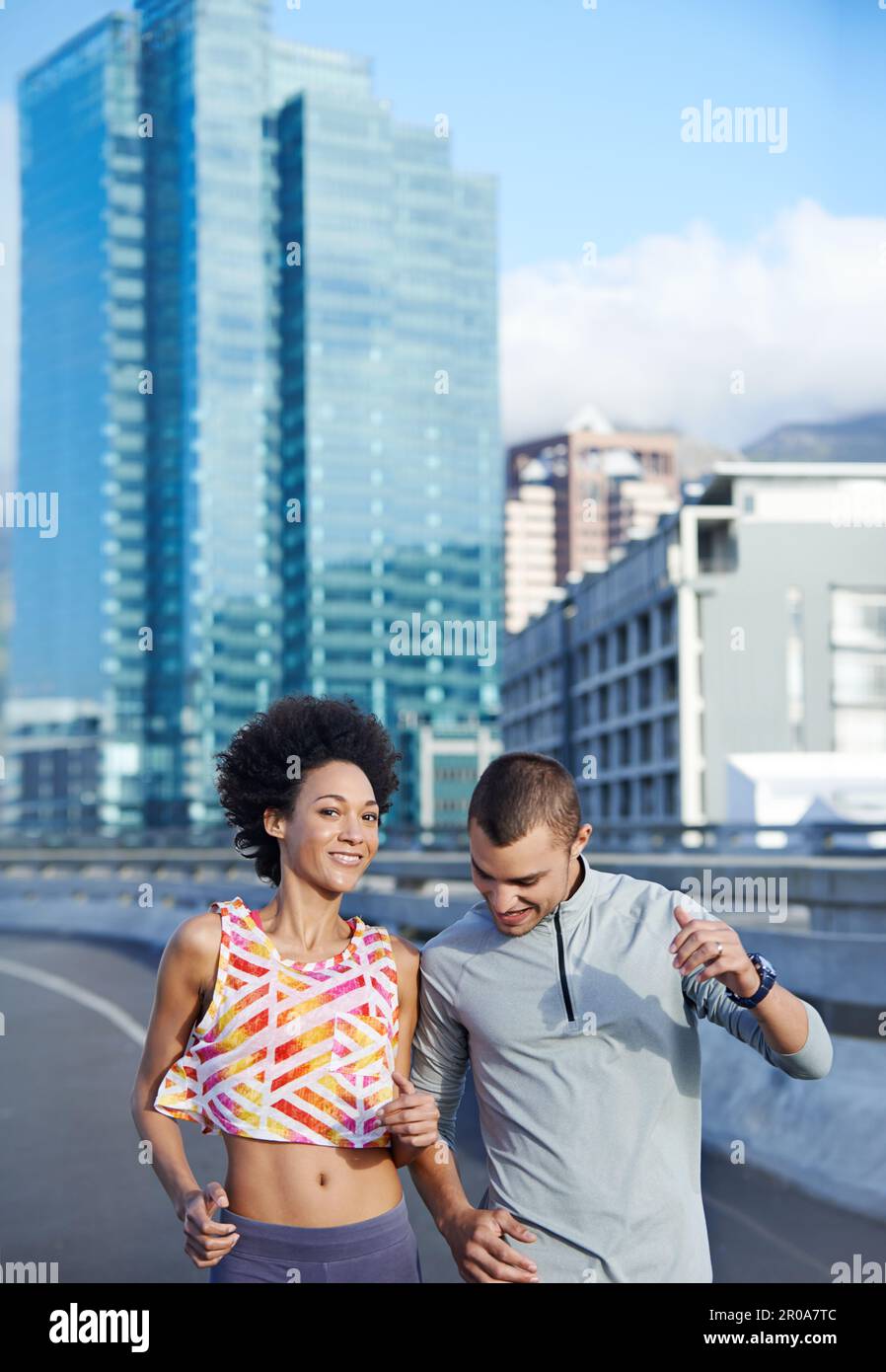 We keep each others feet moving. two friends jogging together through ...
