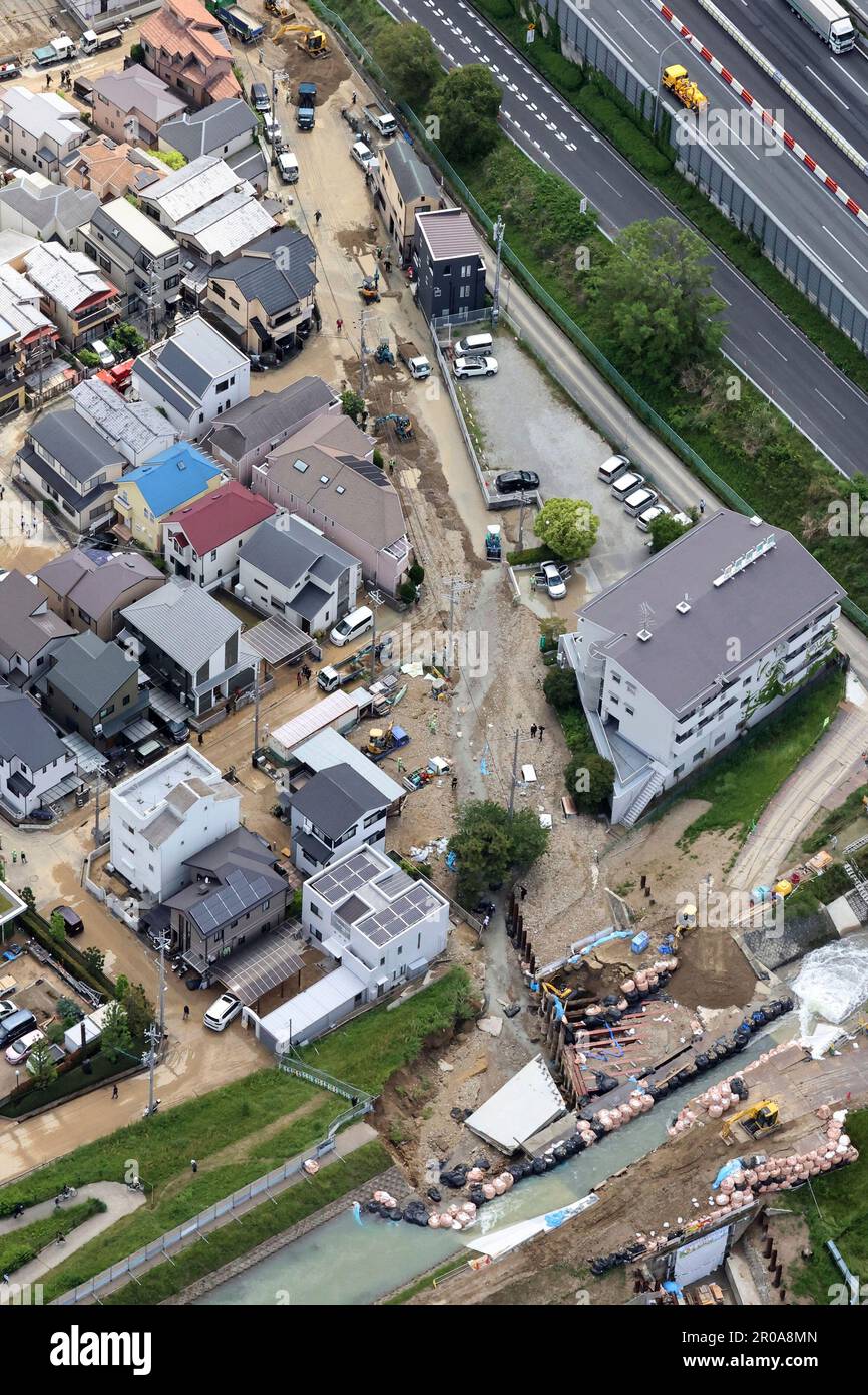 An aerial photo shows the residential area covered with mud in Itami ...