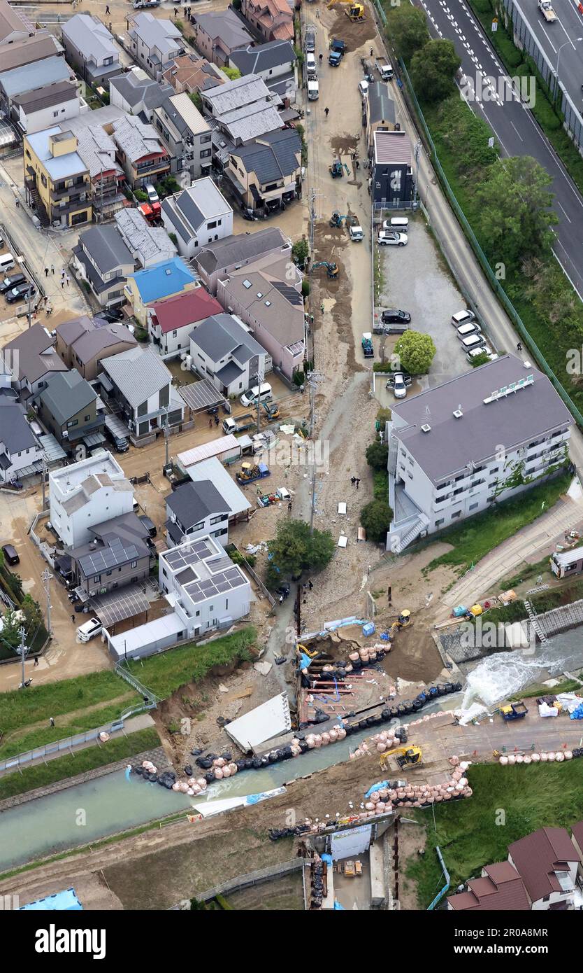 An aerial photo shows the residential area covered with mud in Itami ...