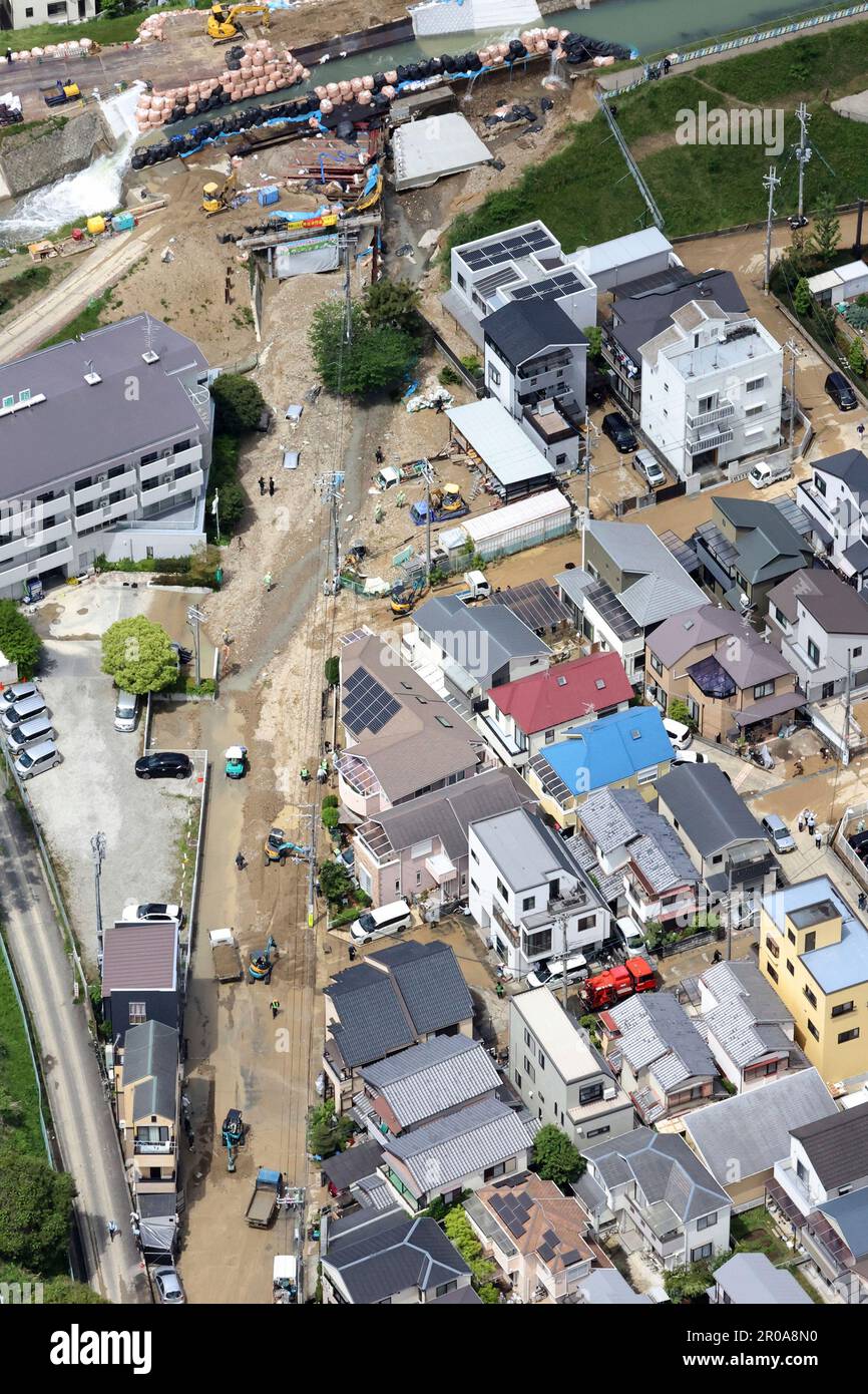 An aerial photo shows the residential area covered with mud in Itami ...