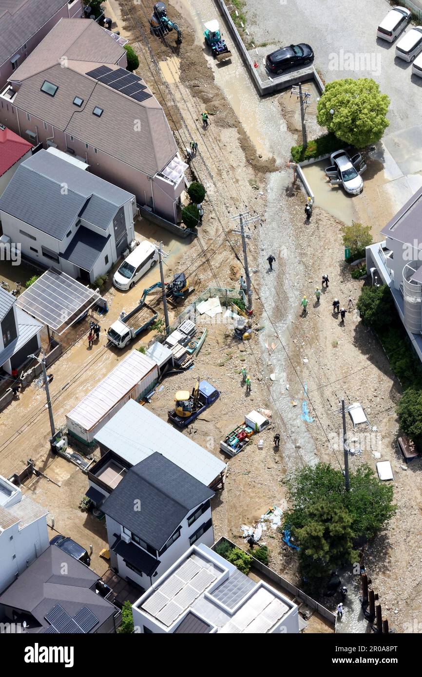 An aerial photo shows the residential area covered with mud in Itami ...