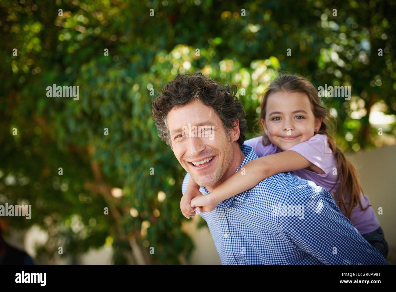 Daddy gives the best piggyback rides. Portrait of a father giving his ...