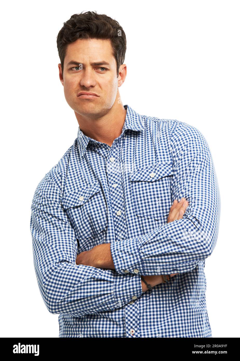 Giving you plenty of attitude. Sneering man standing with his arms ...